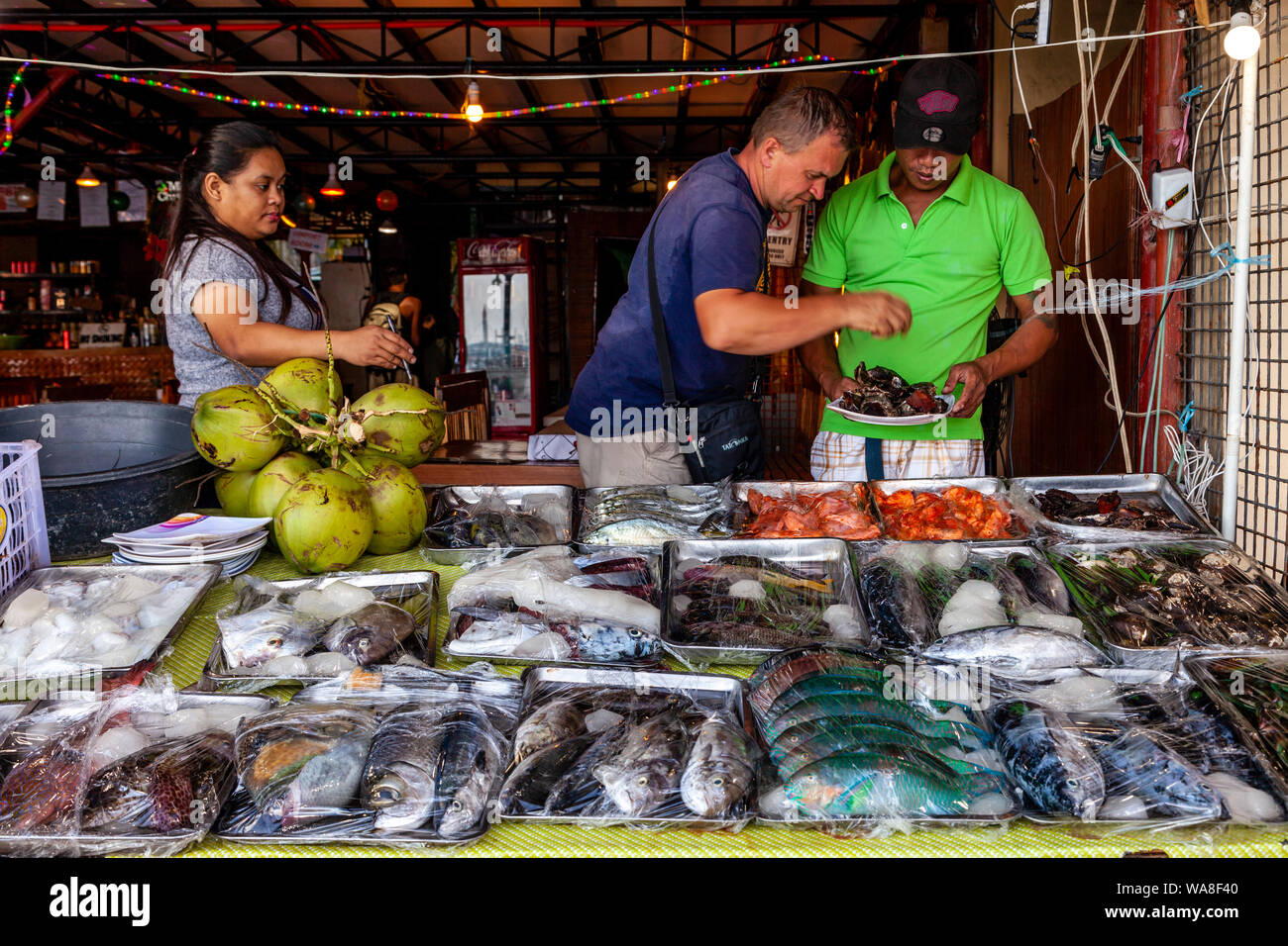 A Tourist Chooses Shellfish From A Restaurant Seafood Display, El Nido ...