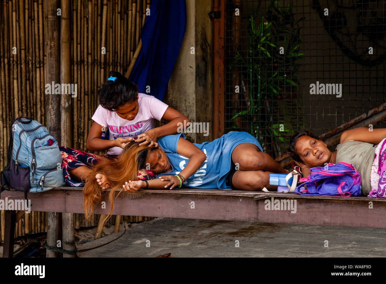 Filipino Women Lying On A Bench, El Nido, Palawan Island, The ...