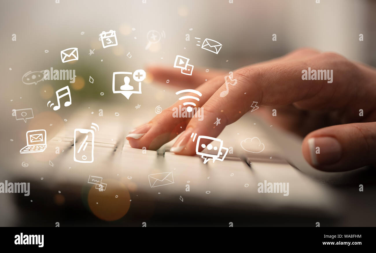 Business woman hand typing on keyboard with drawn application icons ...