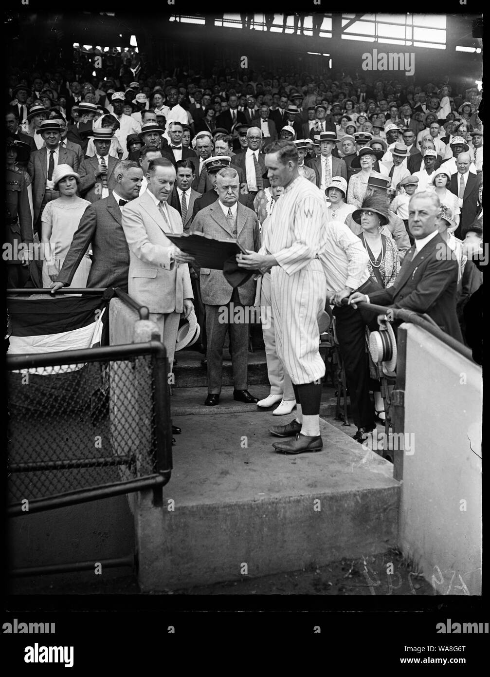 Calvin Coolidge and Walter Johnson in stands; Washington baseball Stock ...