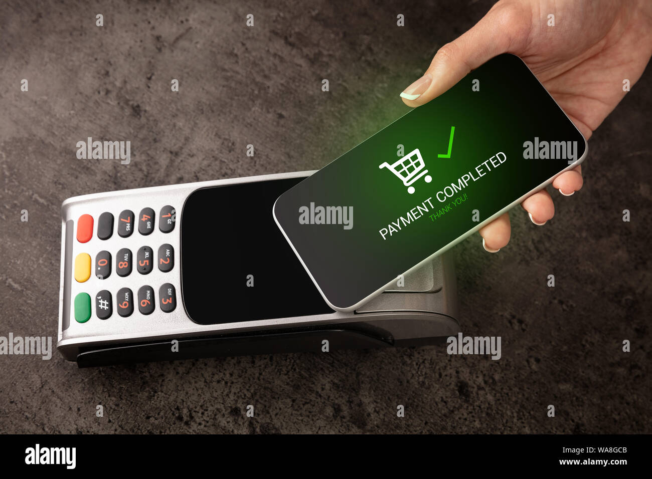 Mobile payment accepted on terminal Stock Photo - Alamy