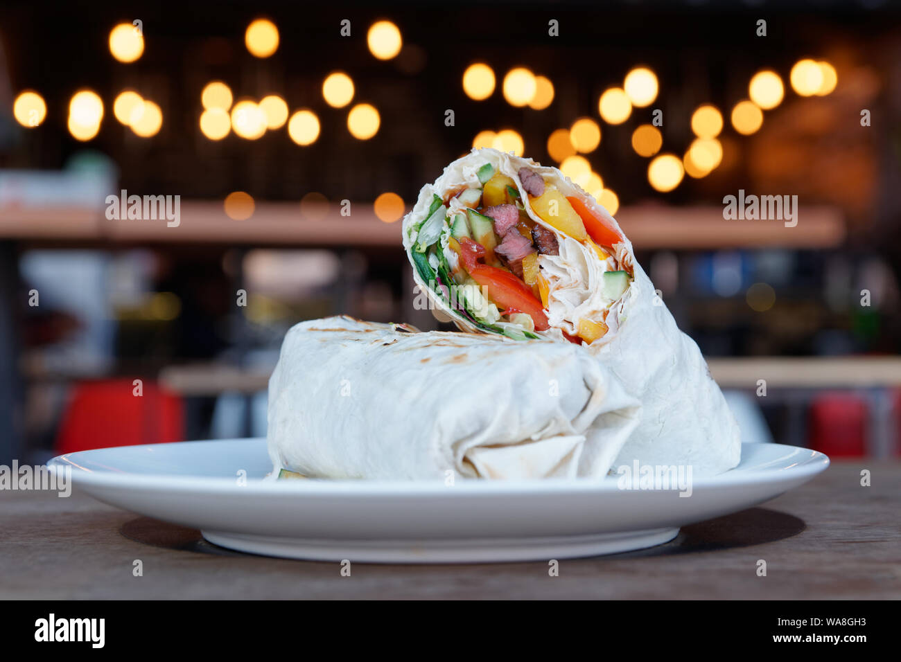Kebap cut in two halves on fast food restaurant table Stock Photo - Alamy
