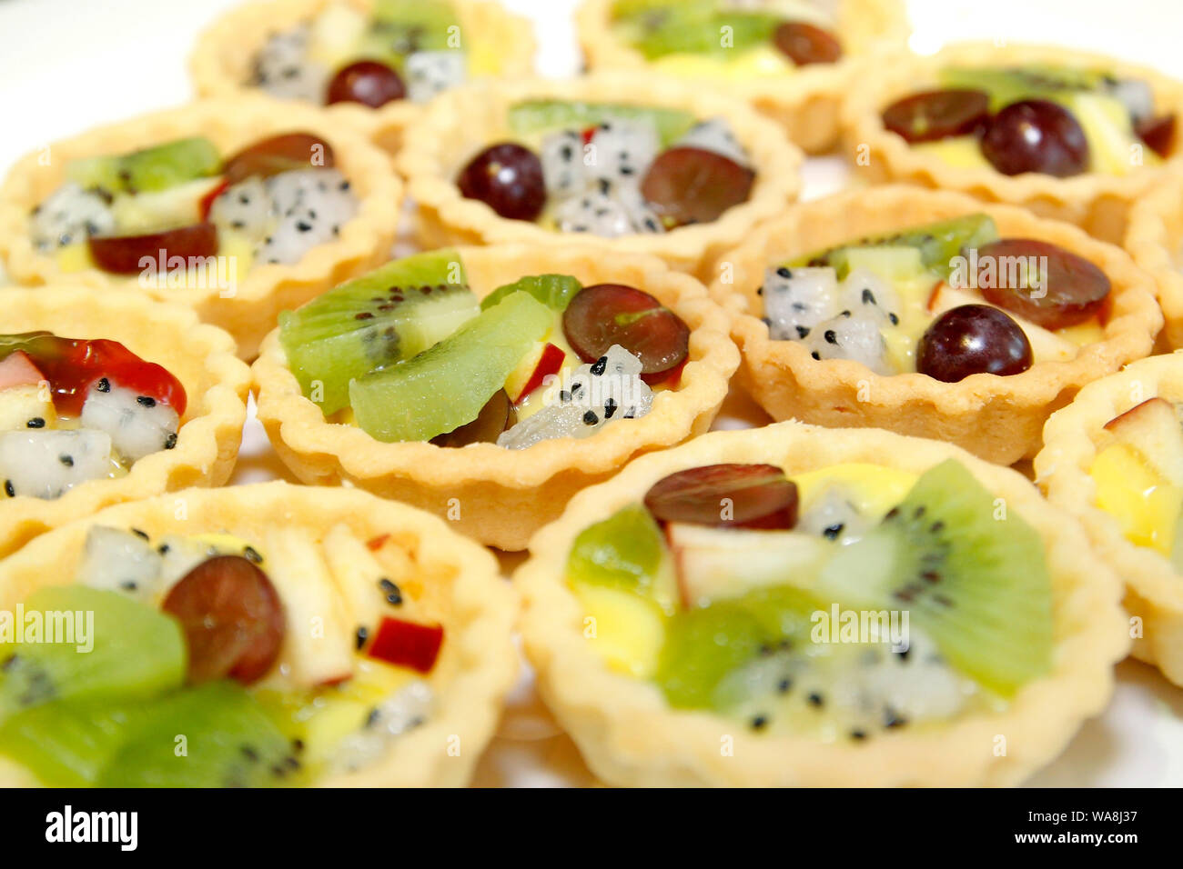 pile of small fruit tart on buffet line Stock Photo - Alamy