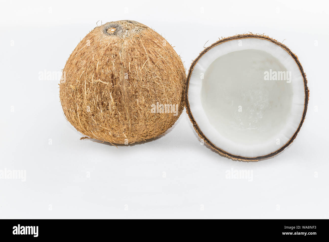 Cut half of the coconut on the white background Stock Photo - Alamy