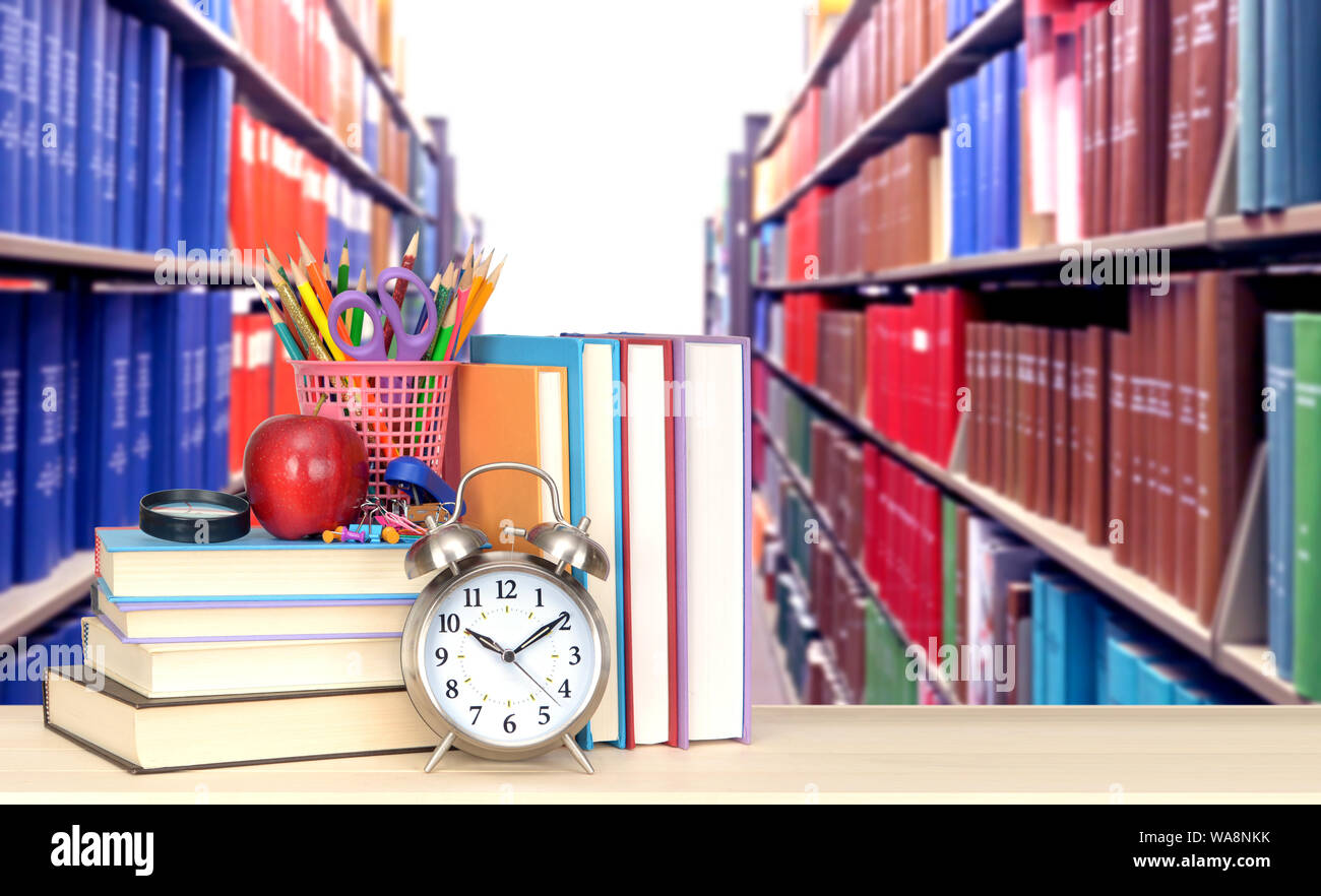 Education concept with stack of book in the very blurry library ...