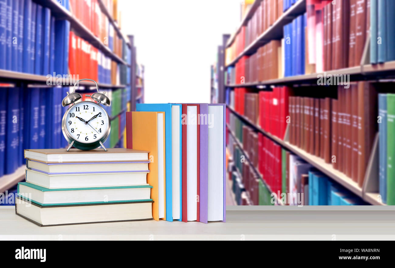 Education concept with stack of book in the very blurry library ...
