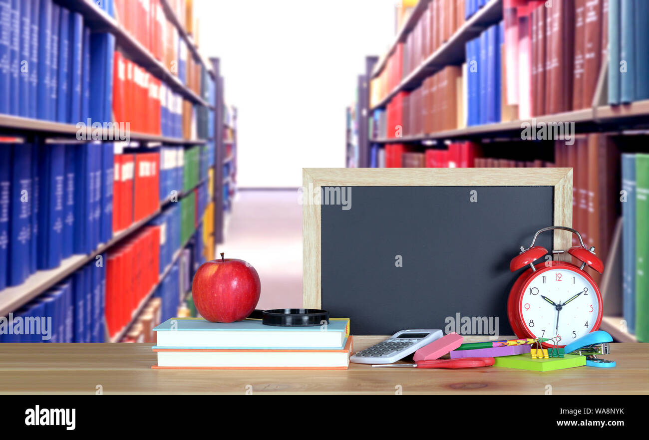 Education concept with stack of book in the very blurry library ...