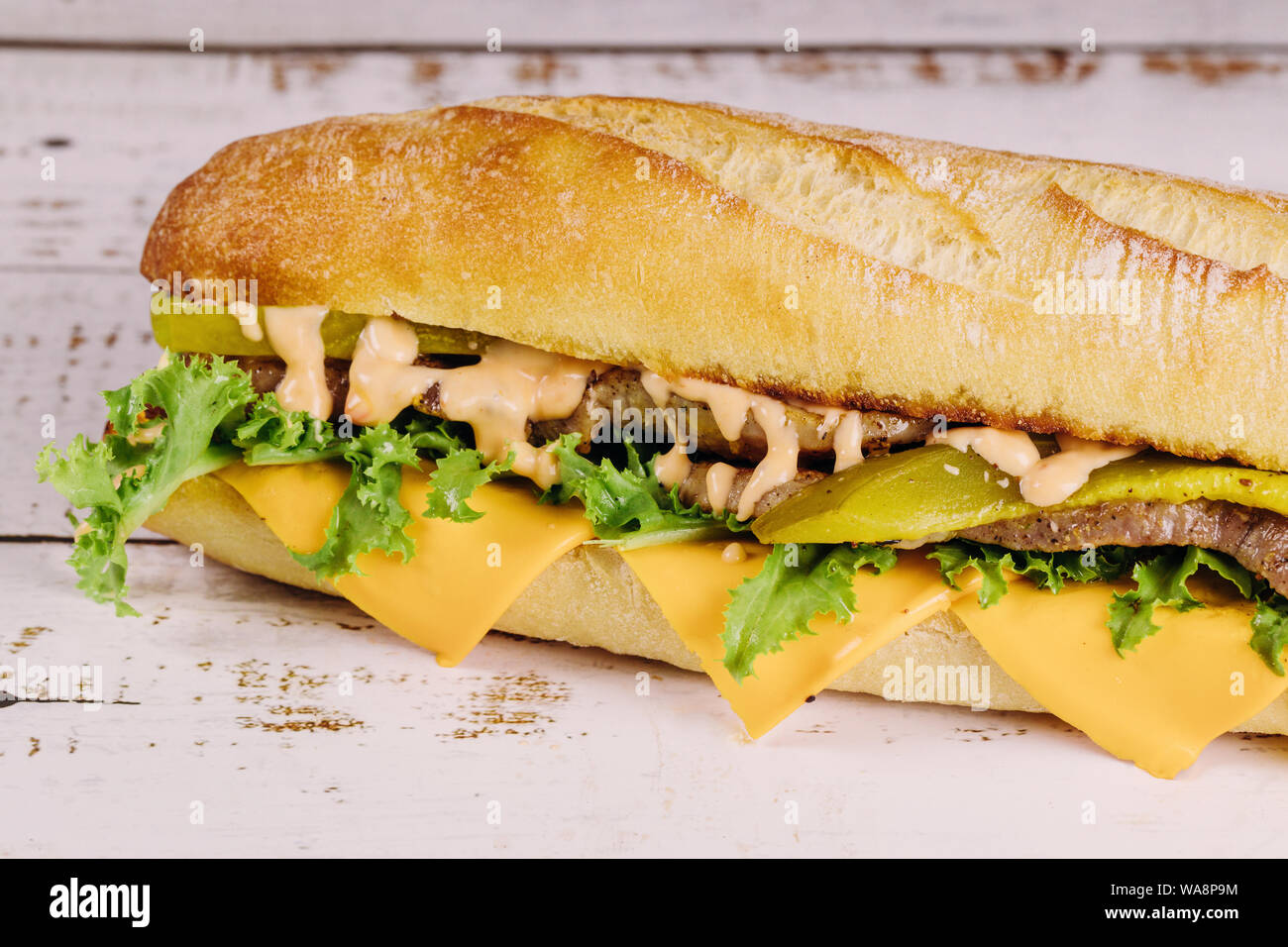 Sub sandwich with cheese, meat and pickles on a white background Stock ...