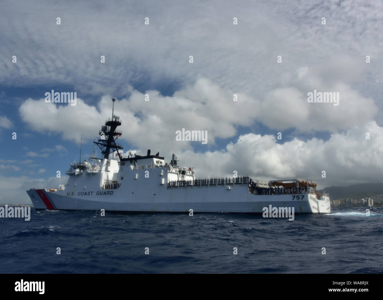 Crewmembers from Coast Guard Cutter Midgett (WMSL 757) line the rails ...