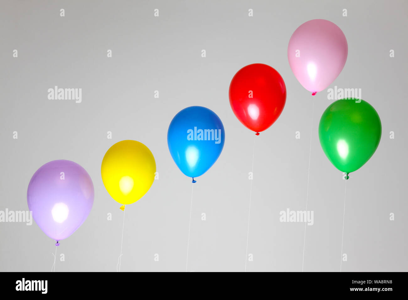 Multi colored helium balloons Stock Photo - Alamy