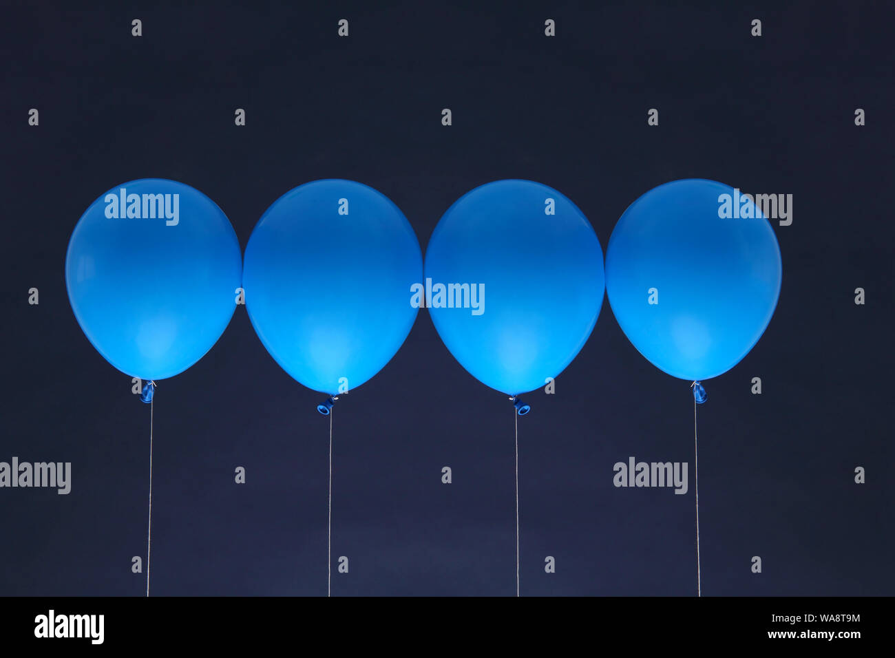 Blue helium balloons in a row Stock Photo - Alamy