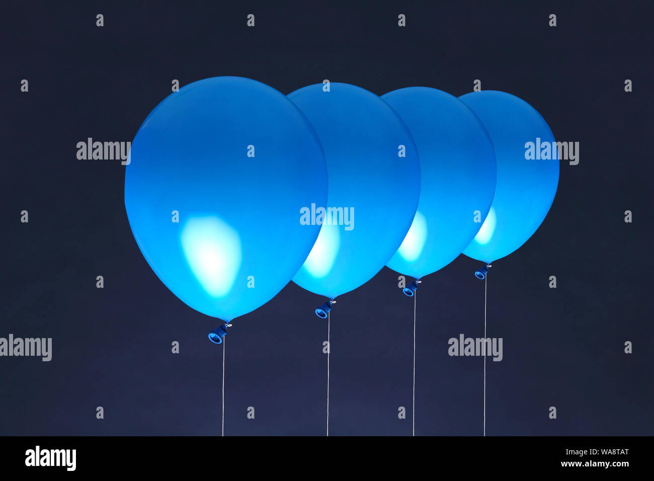 Blue helium balloons in a row Stock Photo - Alamy
