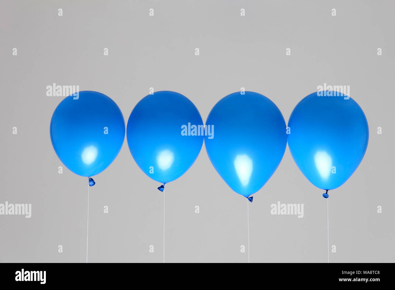 Blue helium balloons in a row Stock Photo - Alamy