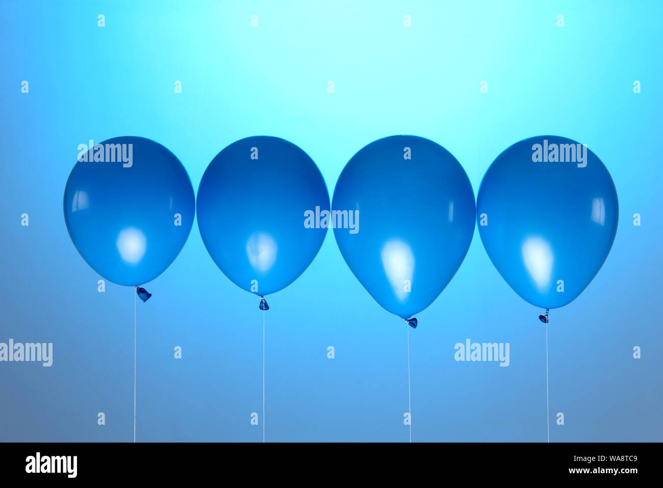Blue helium balloons in a row Stock Photo - Alamy
