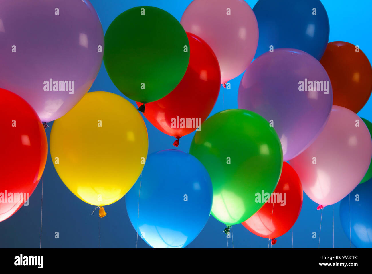 Multi colored helium balloons Stock Photo - Alamy