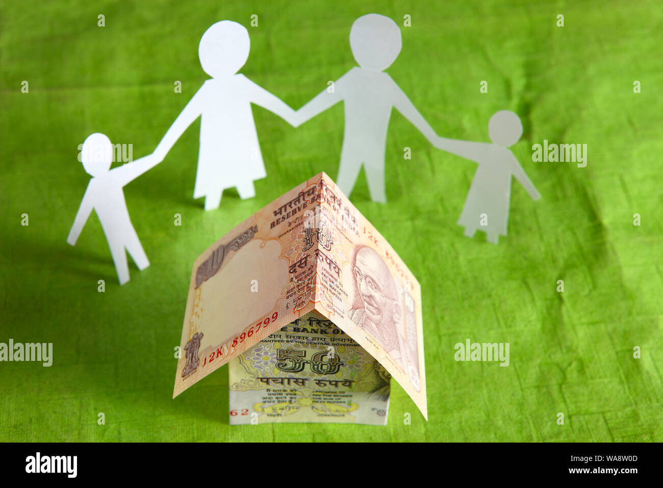 Family paper chain with model home made of banknotes Stock Photo - Alamy