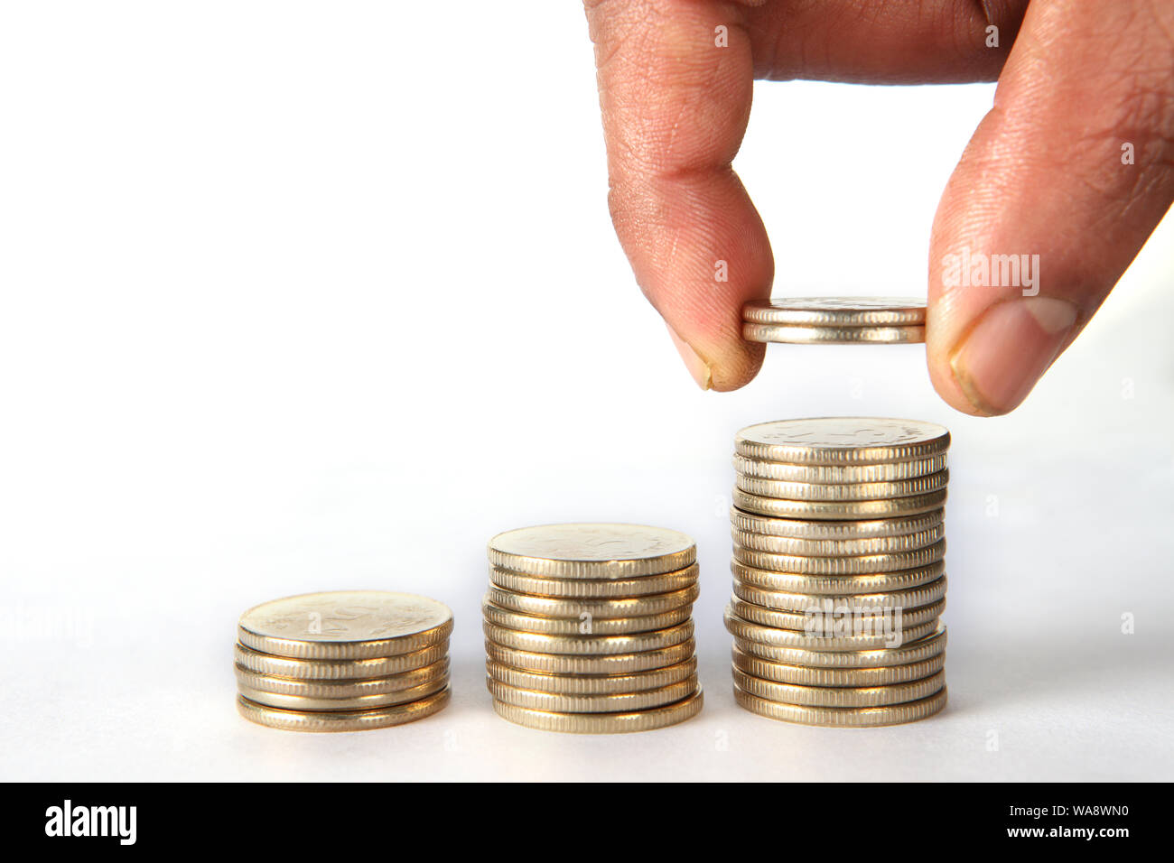 Person hand arranging coins in the shape of bar graph Stock Photo - Alamy