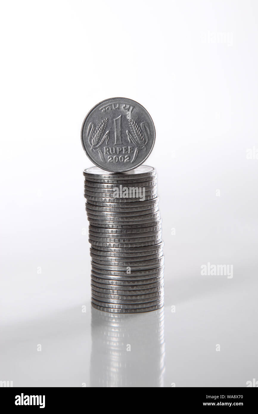 Indian one rupee coin standing on stack of coins Stock Photo - Alamy