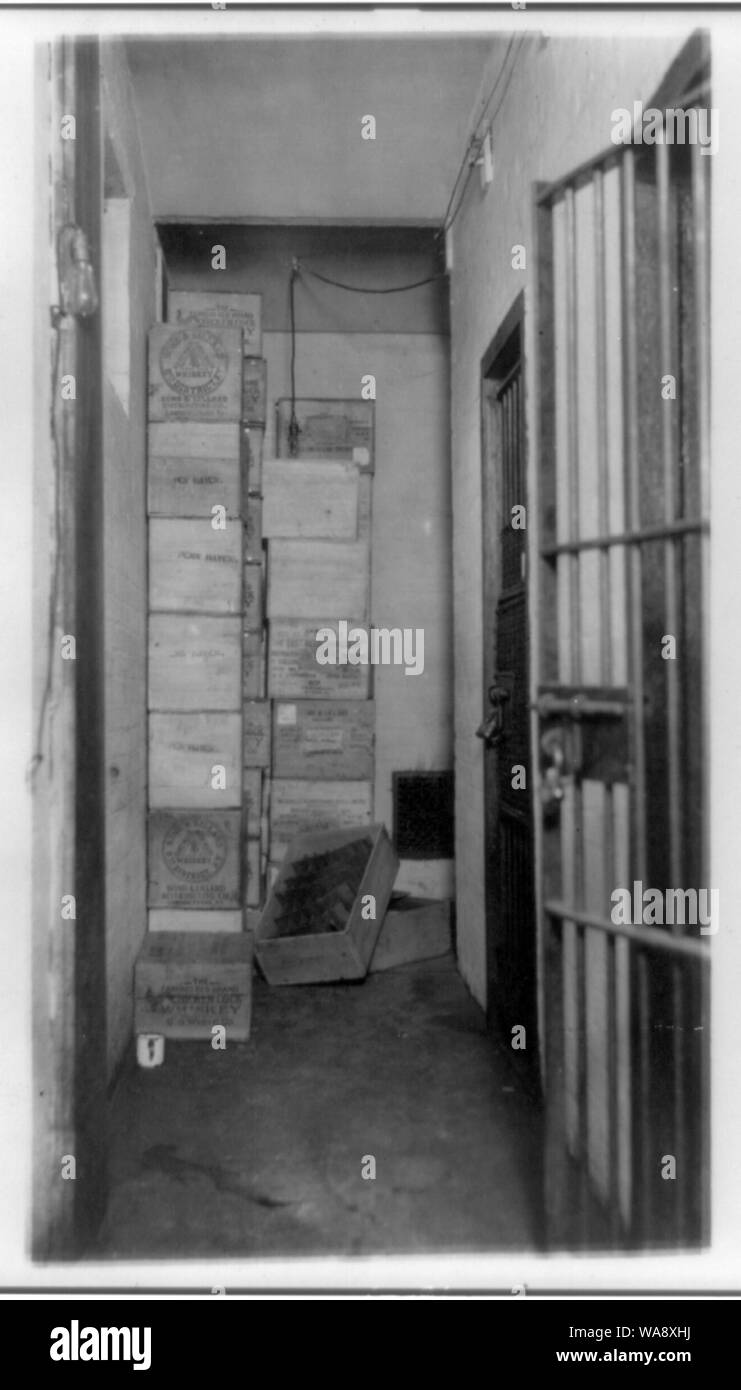 Cases of confiscated() liquor stacked in corner of room with barred ...