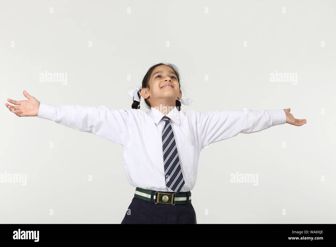 Schoolgirl standing with her arm outstretched Stock Photo - Alamy