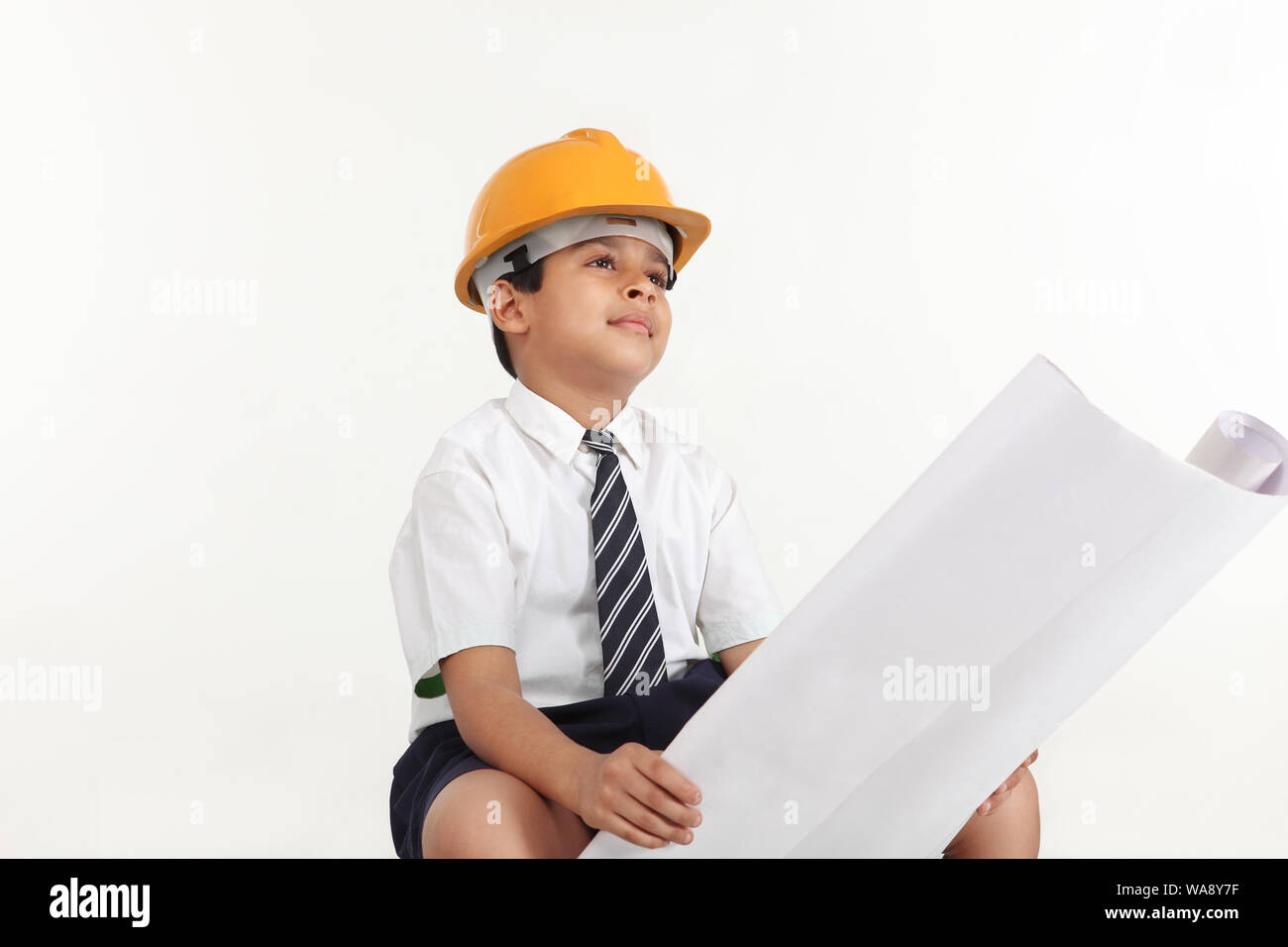 Boy pretending to be an architect and holding a blueprint Stock Photo ...