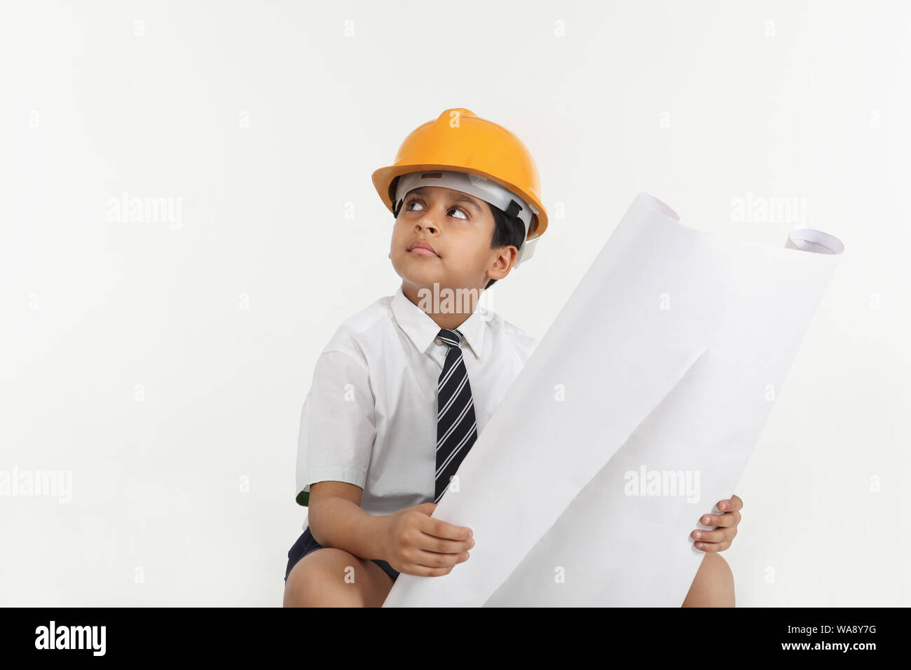 Boy pretending to be an architect and holding a blueprint Stock Photo ...