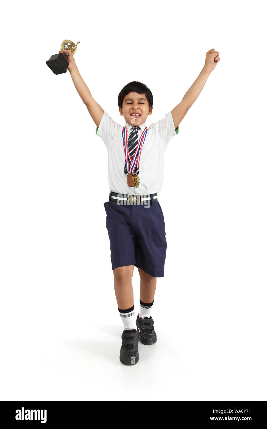 Schoolboy celebrating his success with trophy Stock Photo - Alamy