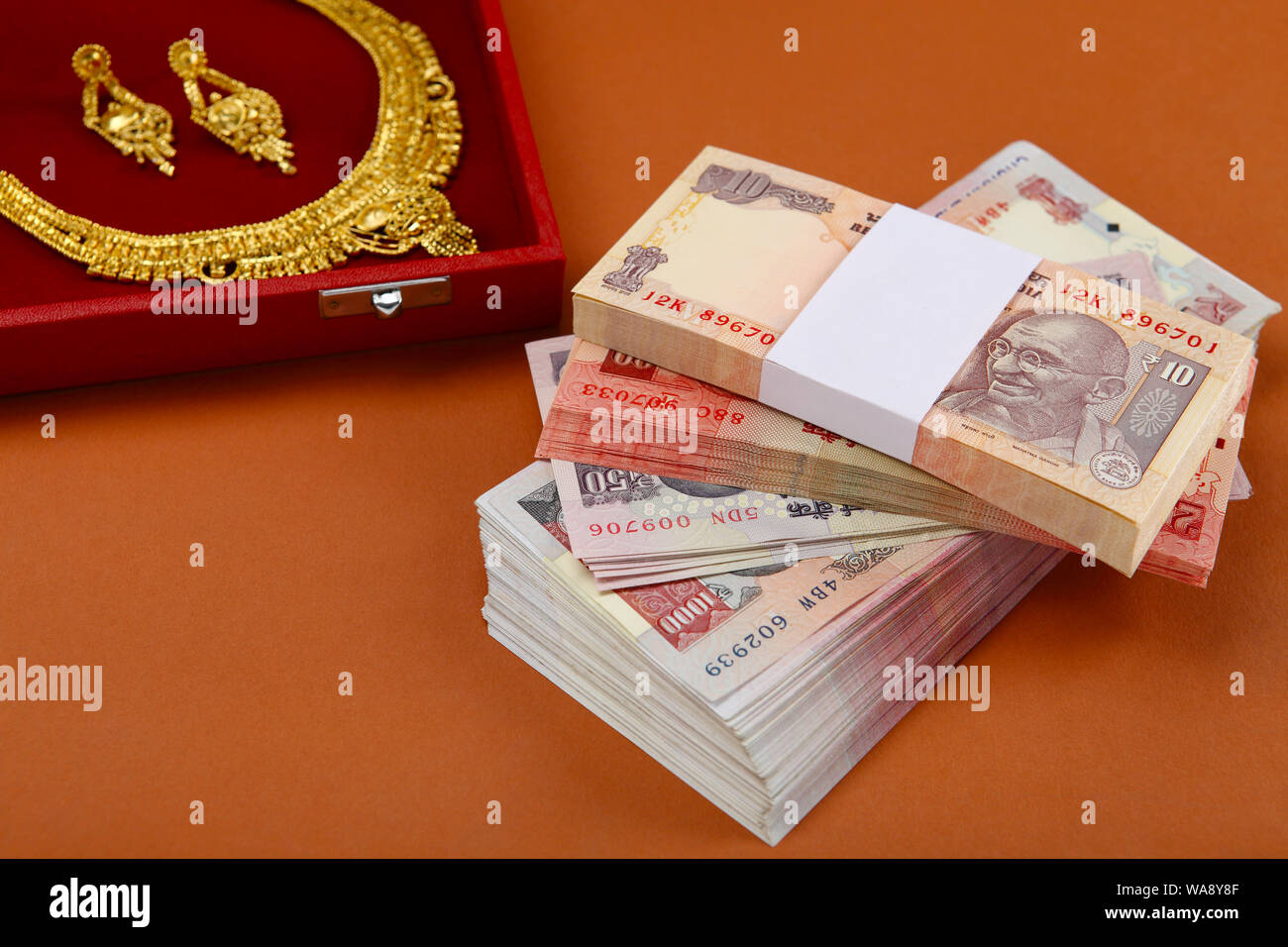 Gold jewelry with banknotes Stock Photo - Alamy
