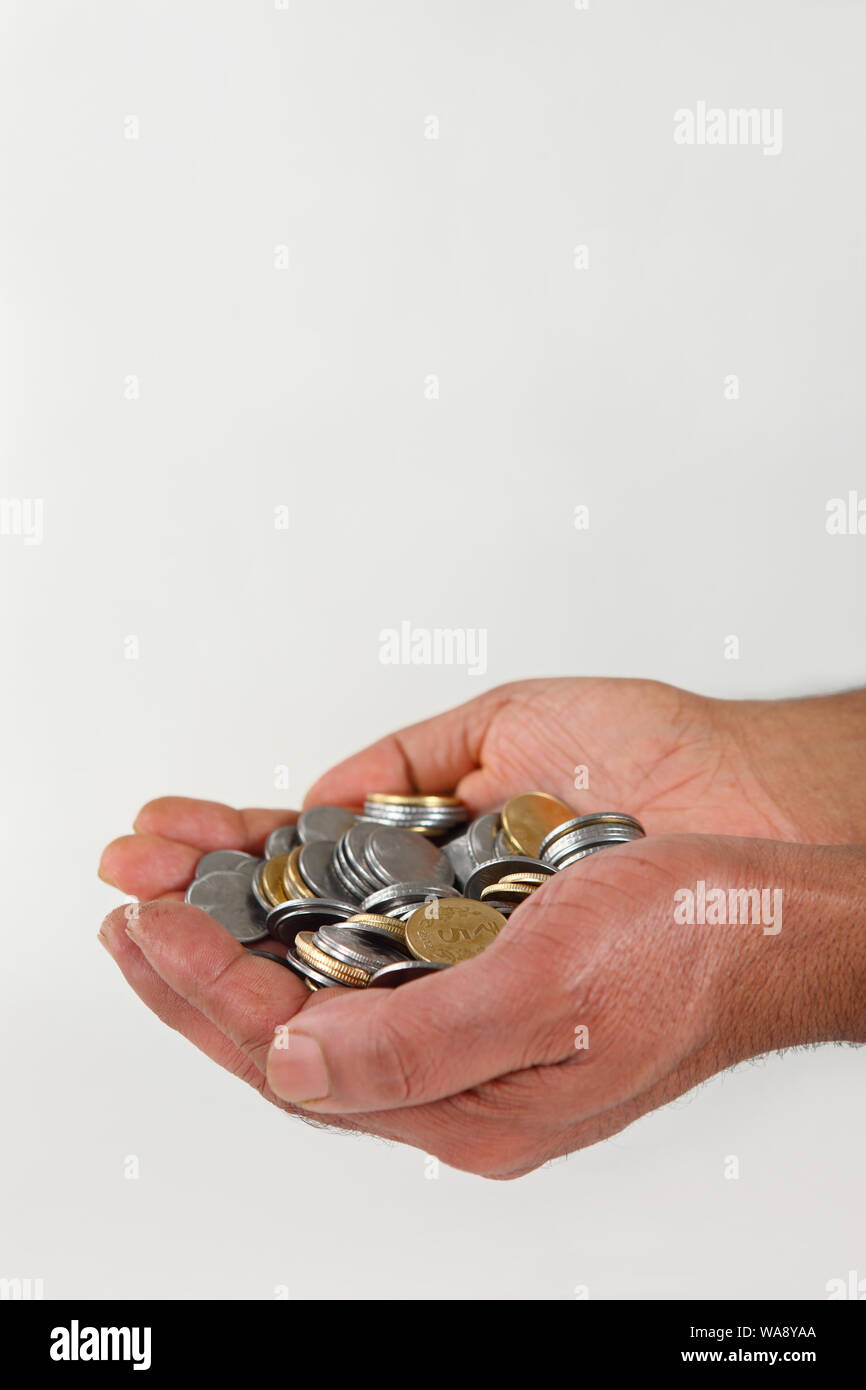 Man cupping hands with coins isolated on white background Stock Photo ...