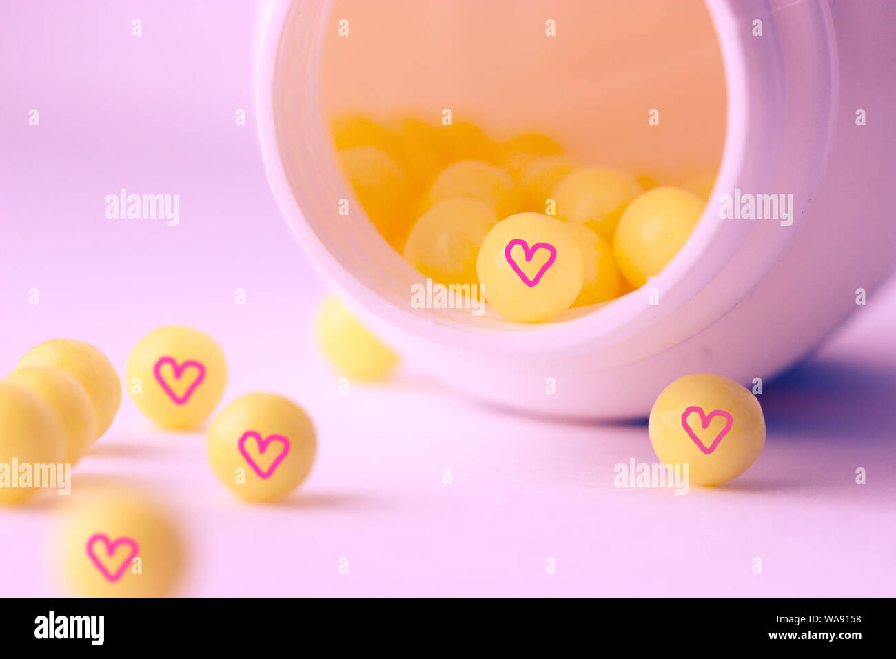 Pills on white background. Heart disease cure Stock Photo - Alamy