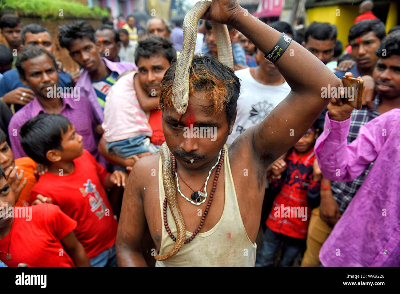 A Snake Charmer and local villagers seen showing different tricks with ...