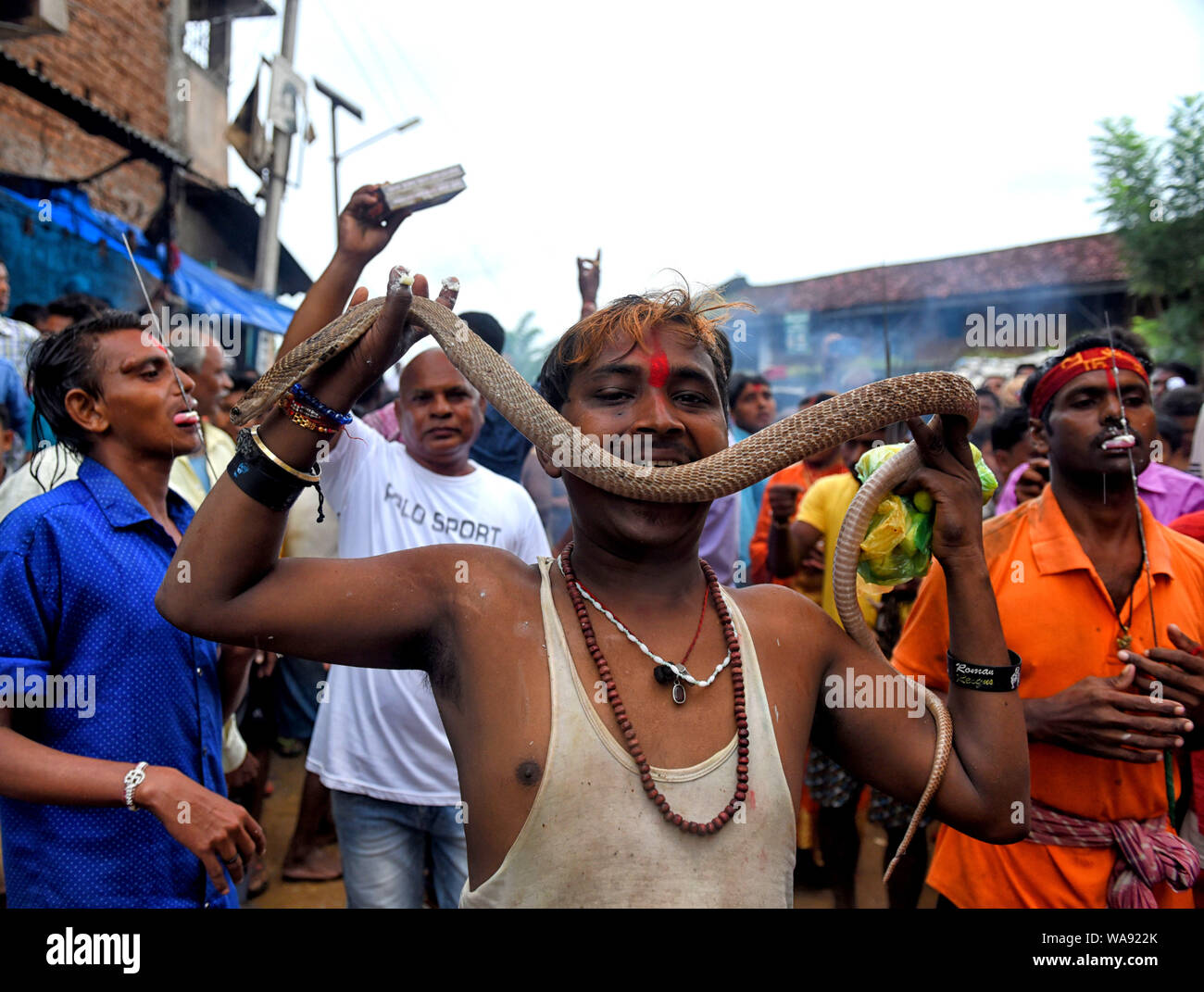 A Snake Charmer and local villagers seen showing different tricks with ...