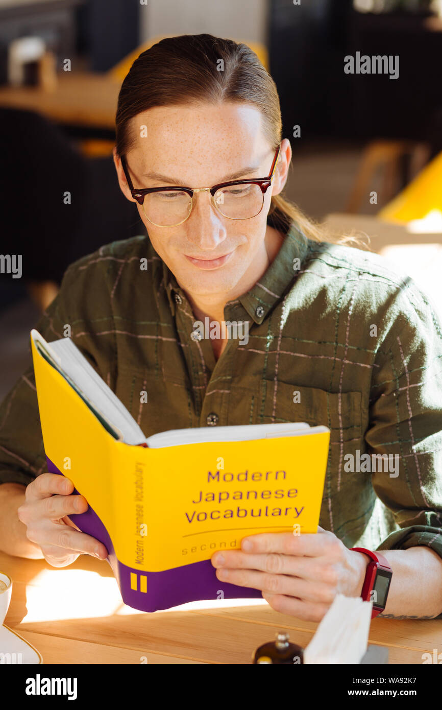 Nice intelligent man studying modern Japanese vocabulary Stock Photo ...