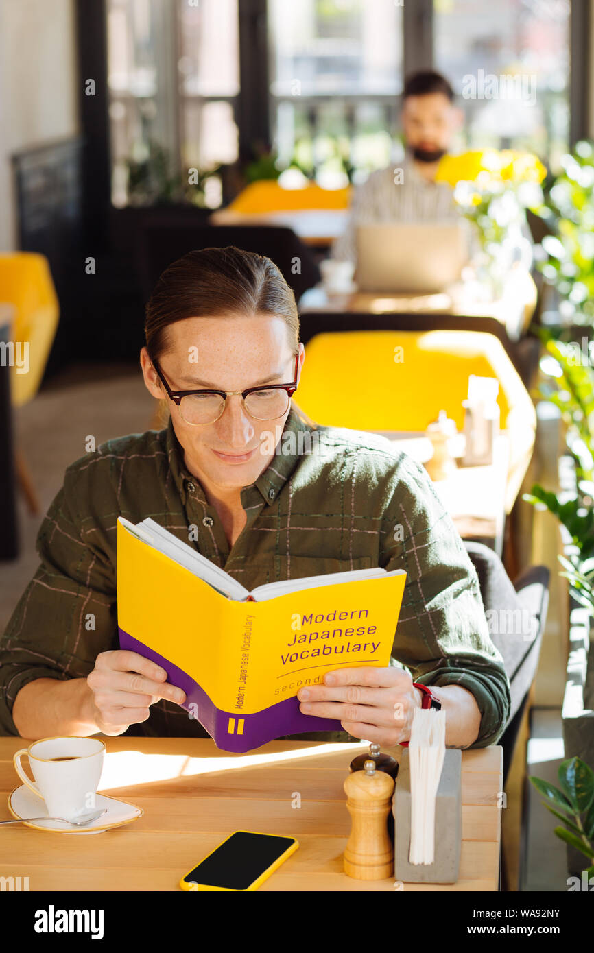 Positive good looking man enjoying studying new languages Stock Photo ...
