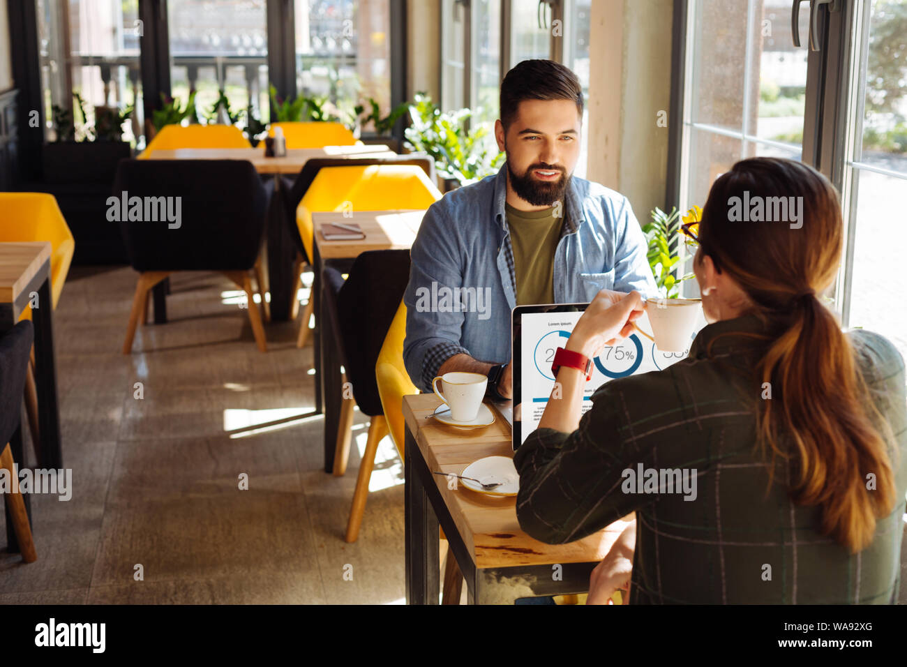 Nice positive man speaking with his colleague Stock Photo - Alamy