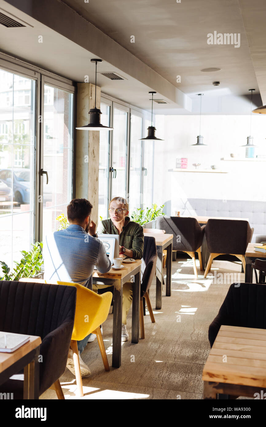 Nice good looking men talking about work issues Stock Photo - Alamy