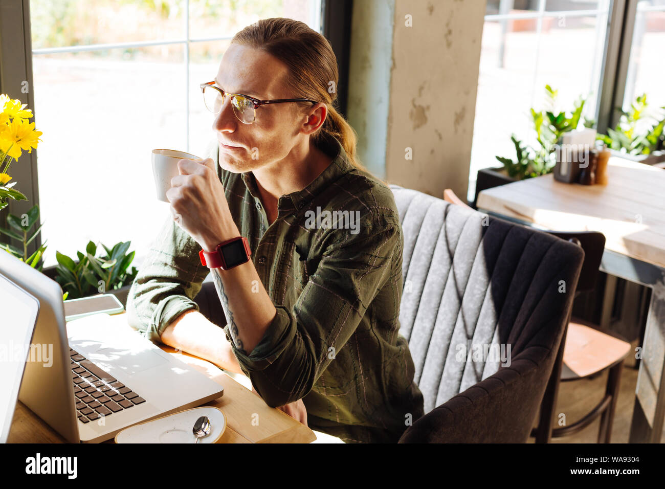 Serious thoughtful man having a break for coffee Stock Photo - Alamy
