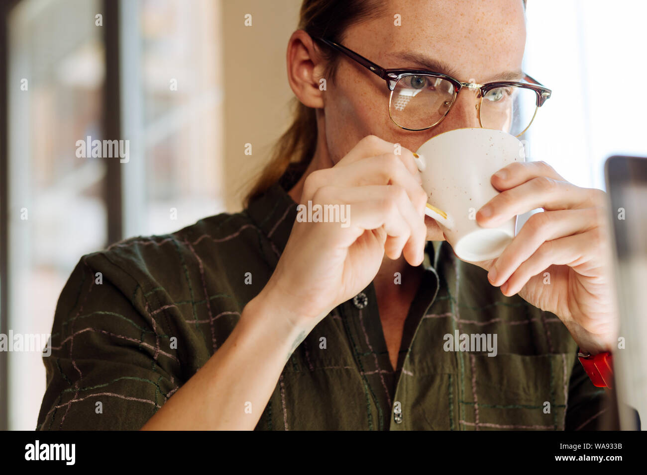 Nice smart man drinking a cup of coffee Stock Photo - Alamy