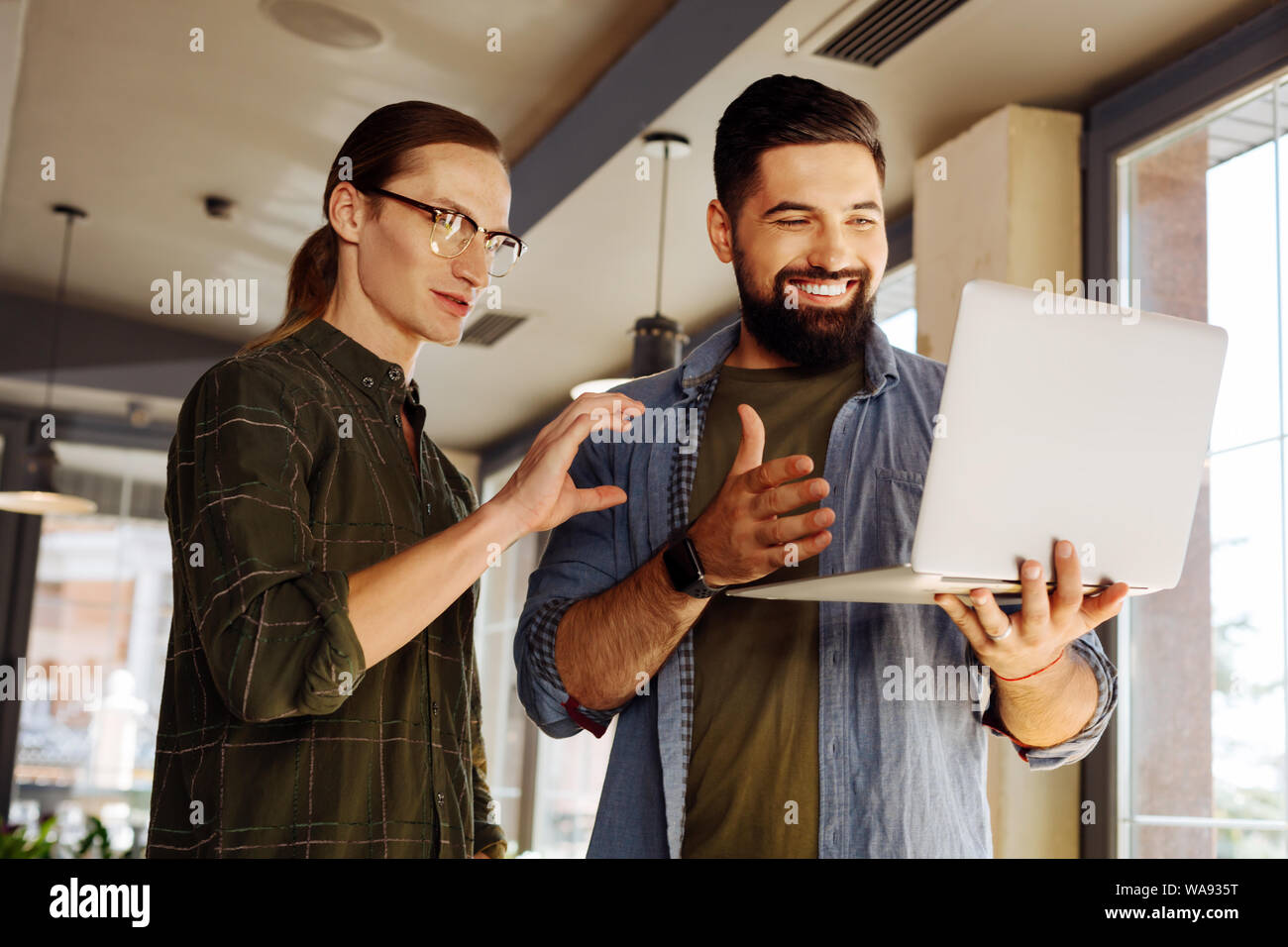 Two handsome adult men speaking hi-res stock photography and images - Alamy