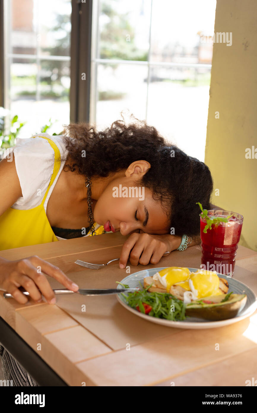 Nice young woman lying on the table Stock Photo - Alamy