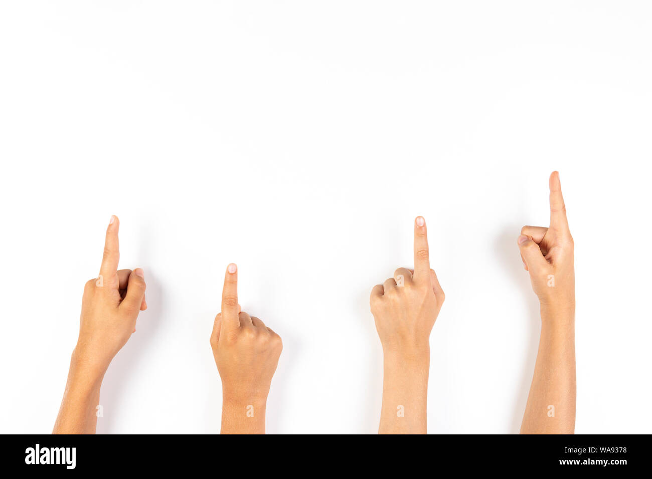 Kids hands pointing up with fingers to something over white background ...