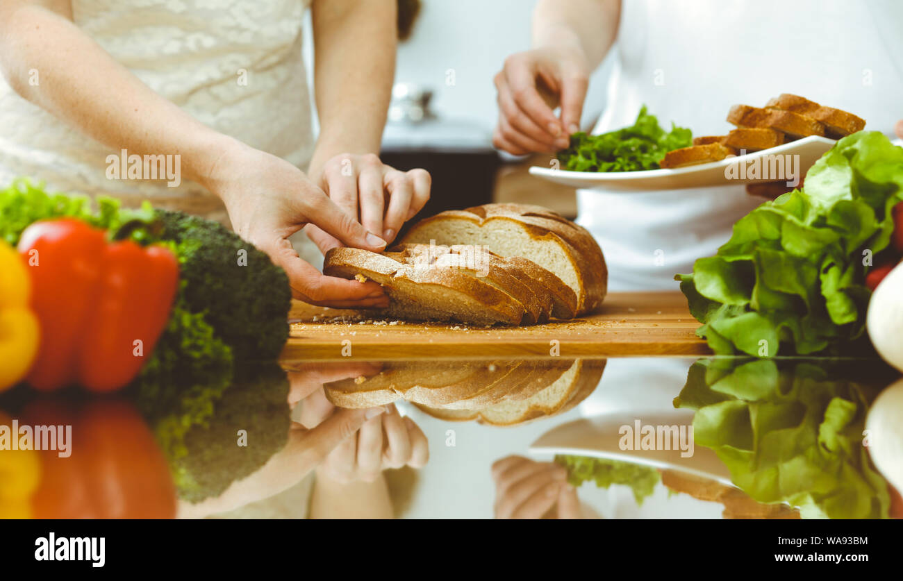 Closeup of human hands cooking in kitchen. Mother and daughter or two ...