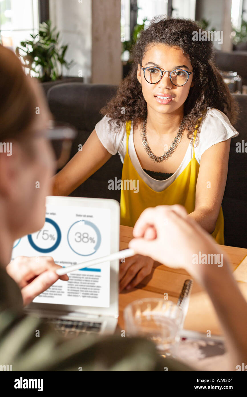Nice serious woman listening to her colleague Stock Photo - Alamy Nice serious woman listening to her colleague Stock Photo - Alamy