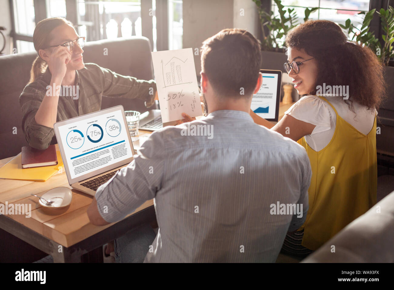 Positive young people sharing their ideas with each other Stock Photo ...