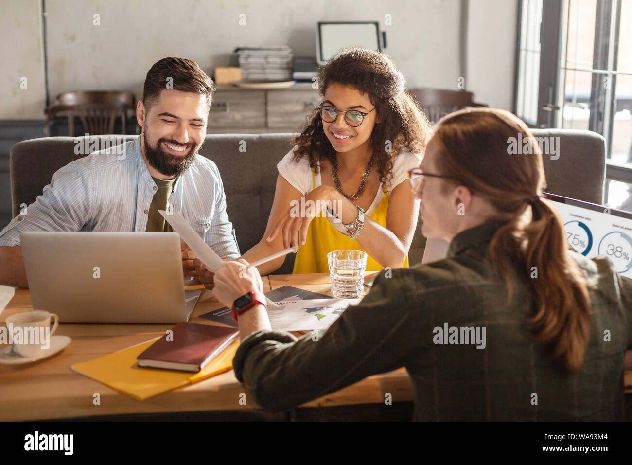 Positive nice people looking at the documents Stock Photo - Alamy