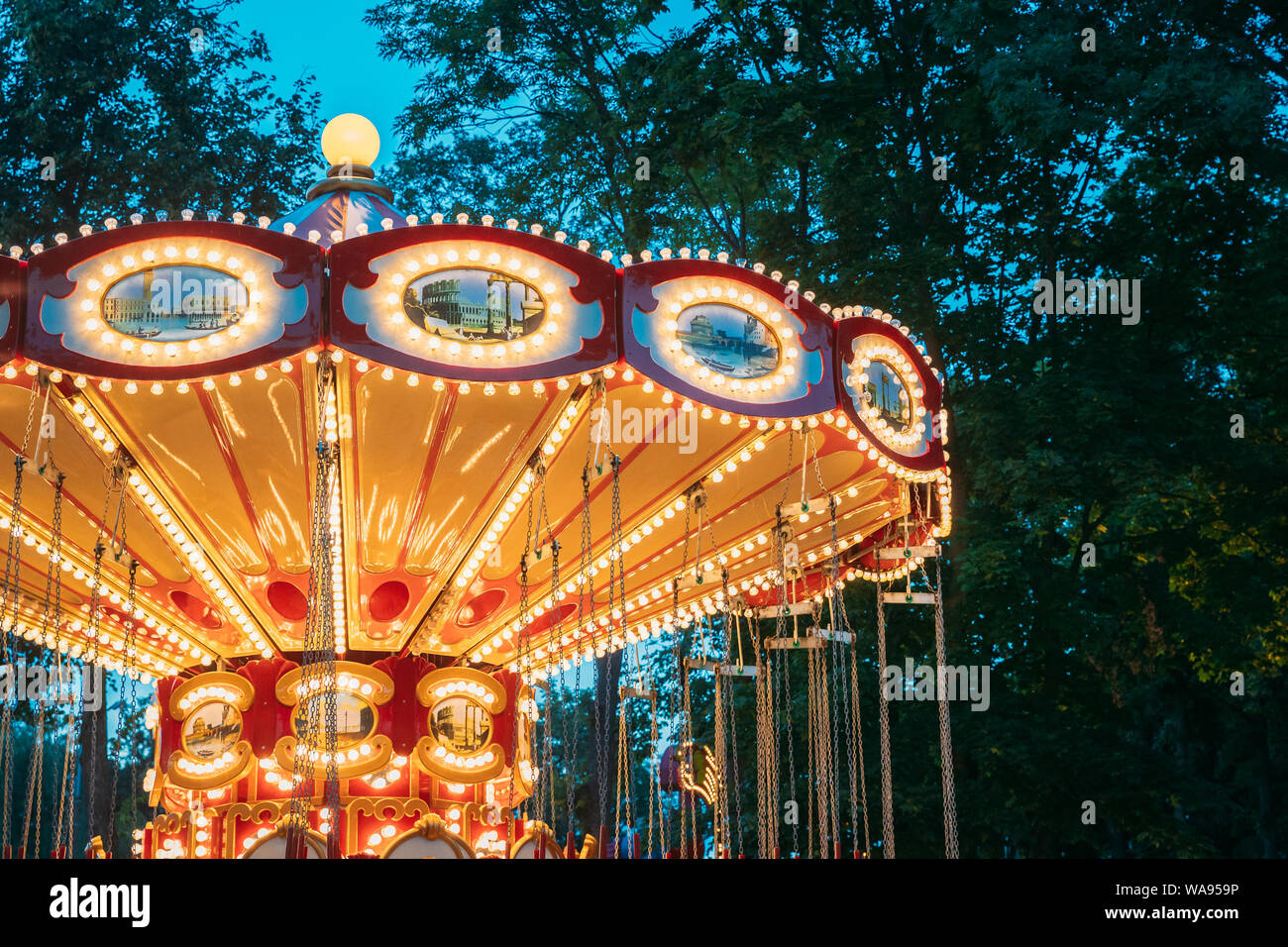 Brightly Illuminated Carousel Merry-Go-Round. Summer Evening In City ...