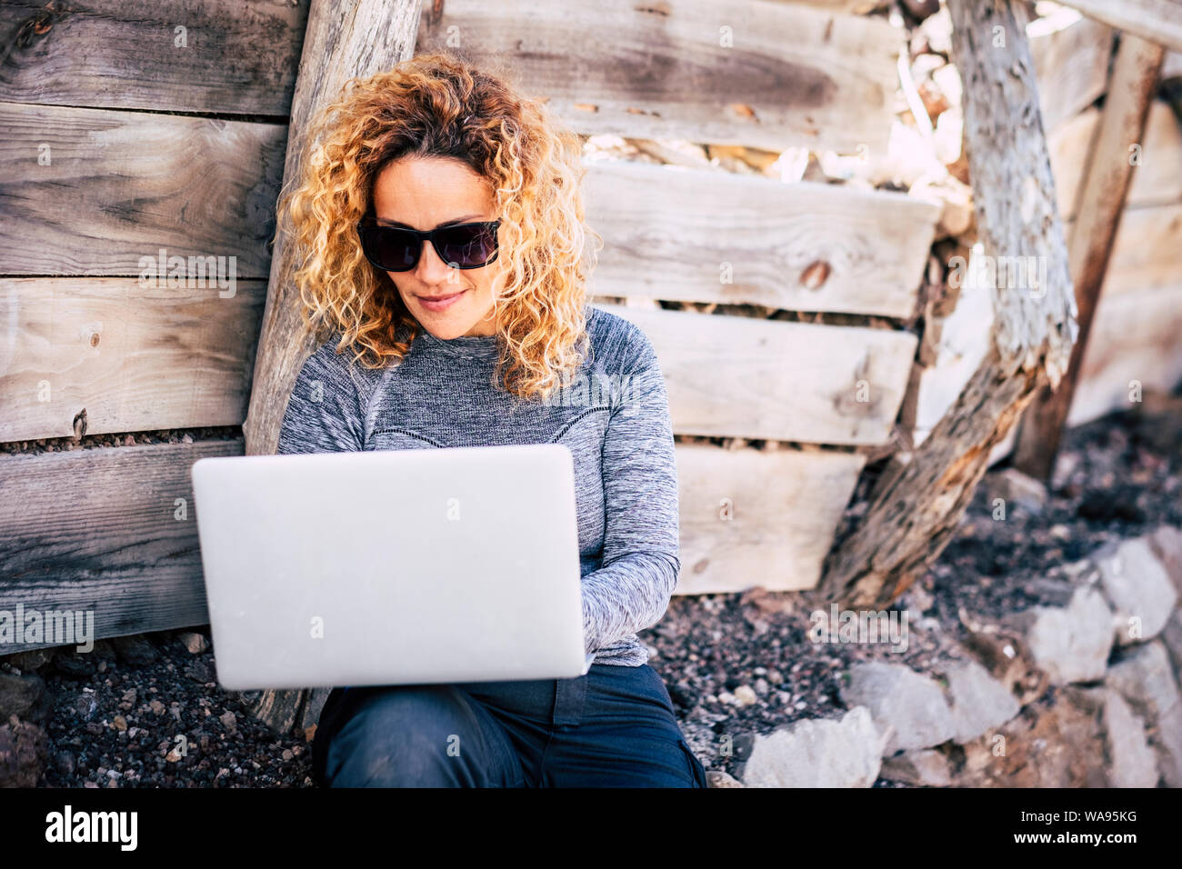 Attractive people adult blonde woman use laptop. computer outdoor ...