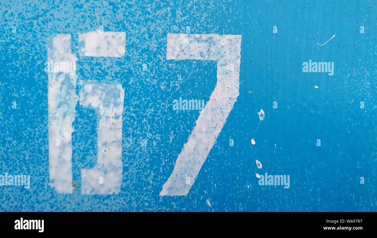 The number 67 with white paint on a cracked blue background Stock Photo ...