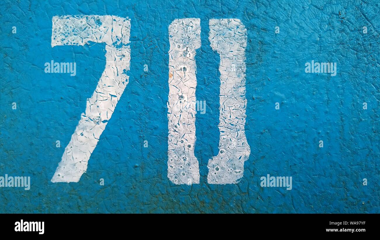 The number 70 with white paint on a cracked blue background Stock Photo ...