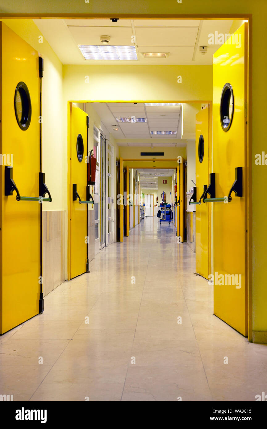 Hospital corridor indoor in yellow tone. Health center interior ...